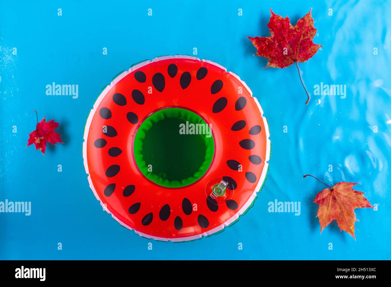 Goodbye, summer background. Watermelon lifebuoy in a swimming pool with ...