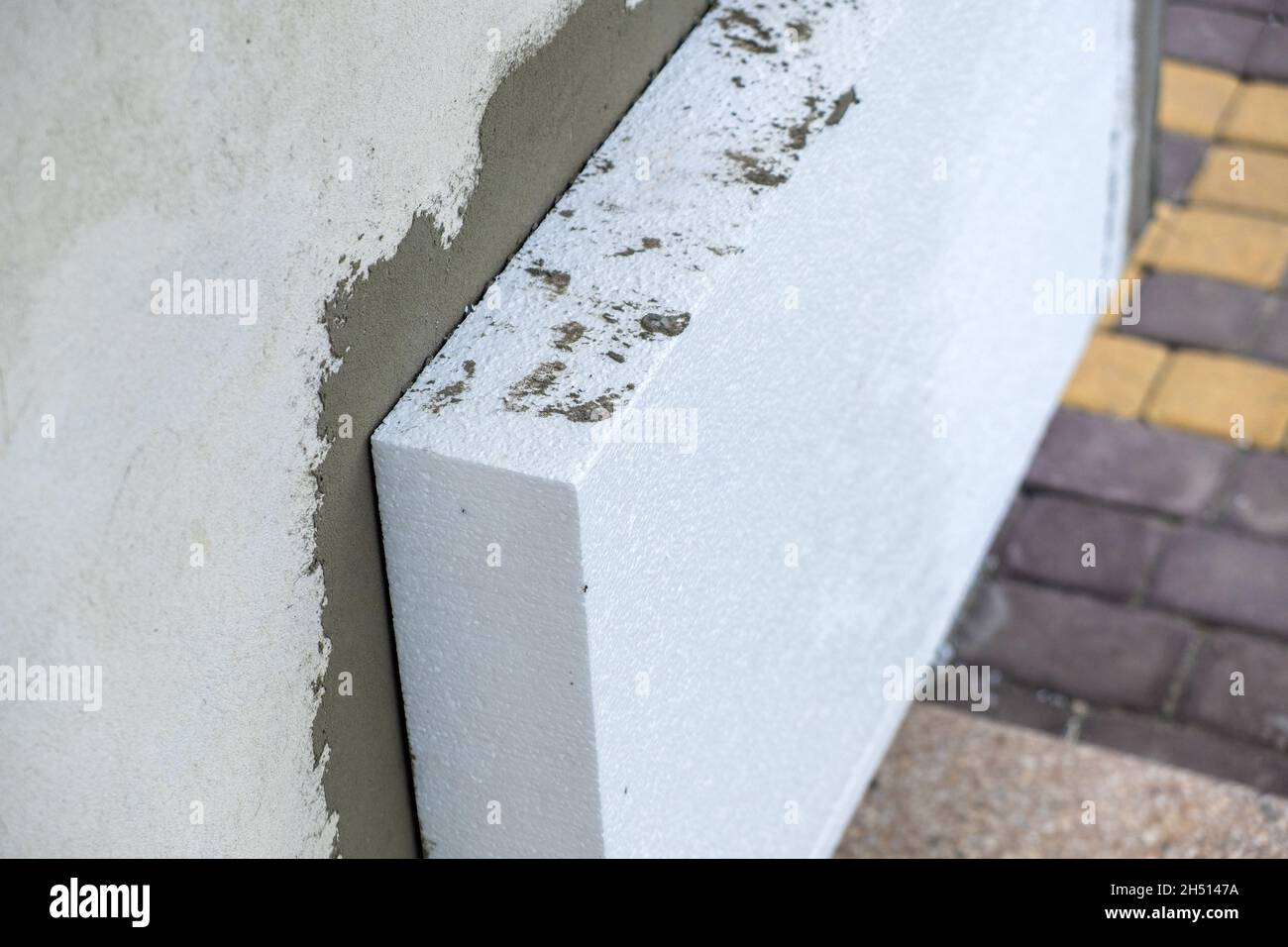 Installation of styrofoam insulation sheets on house facade wall for ...