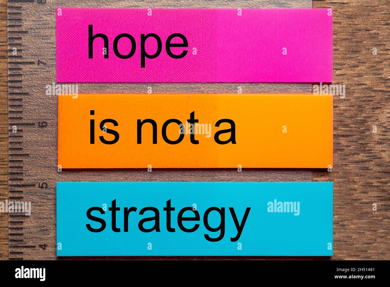 Three bookmark stickers with the words hope is not a strategy on a dark ...