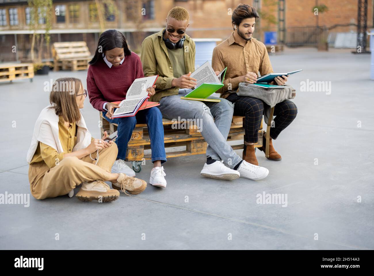 Young students read books at university campus Stock Photo - Alamy
