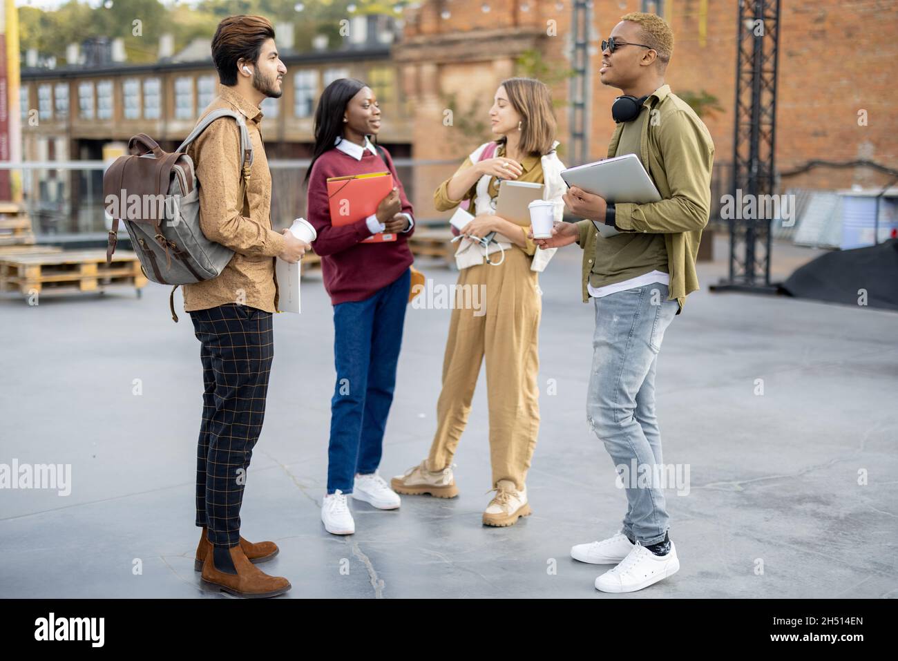 Multiracial students stand and talk outdoor at day Stock Photo - Alamy