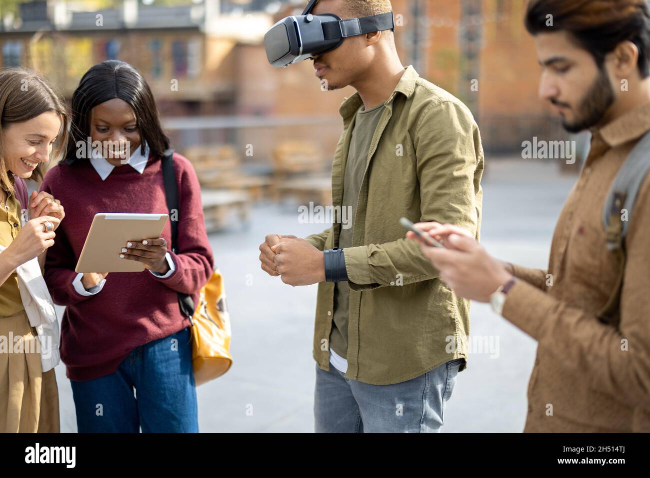 Mixed races students at university campus outdoors Stock Photo - Alamy