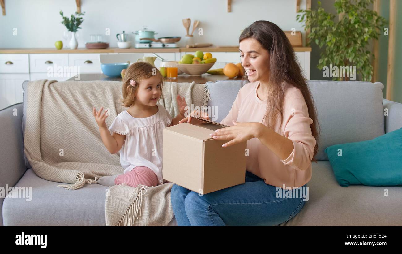 Adorable Girl Unpacking the Order. Happy Mother and Daughter Unpacking ...