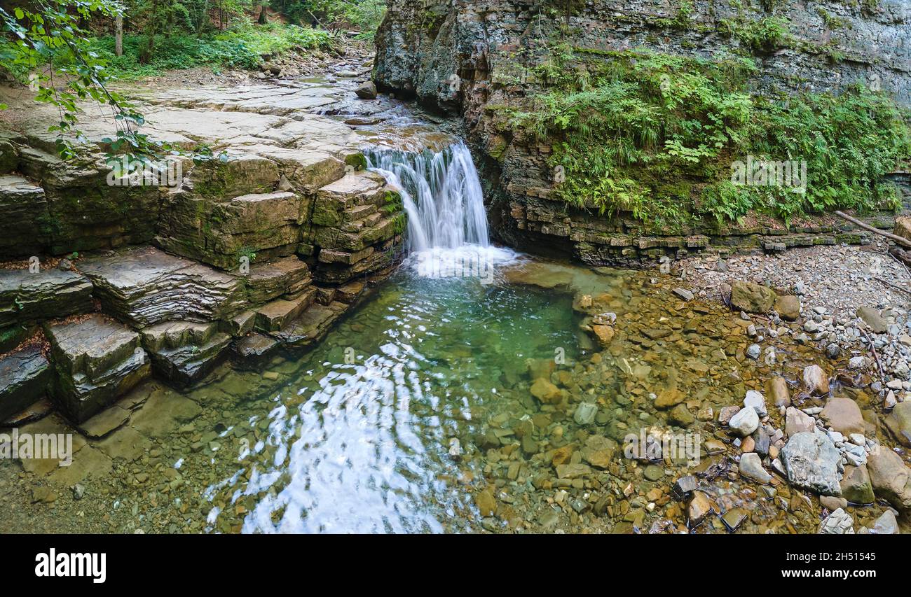 Waterfall on mountain river with white foamy water falling down from ...