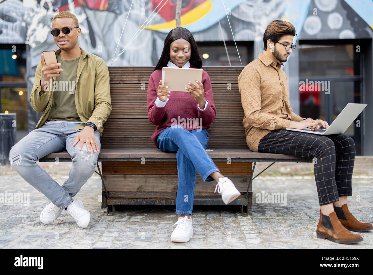 Young students using gadgets at university campus Stock Photo - Alamy
