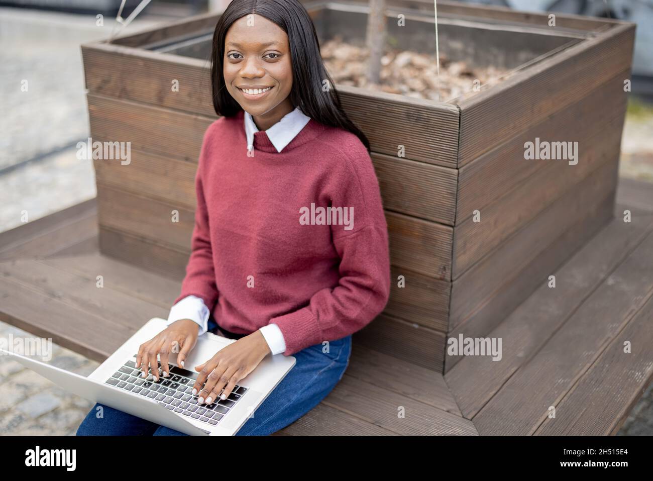 Smiling student black girl with laptop computer Stock Photo - Alamy