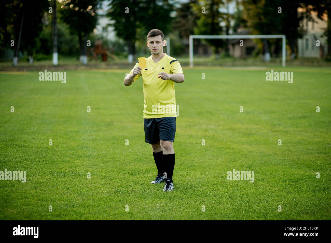 Soccer referee to point out a yellow card to a player in the soccer ...