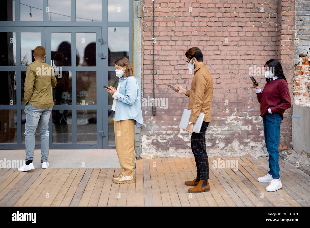 Students waiting in queue at university campus Stock Photo - Alamy