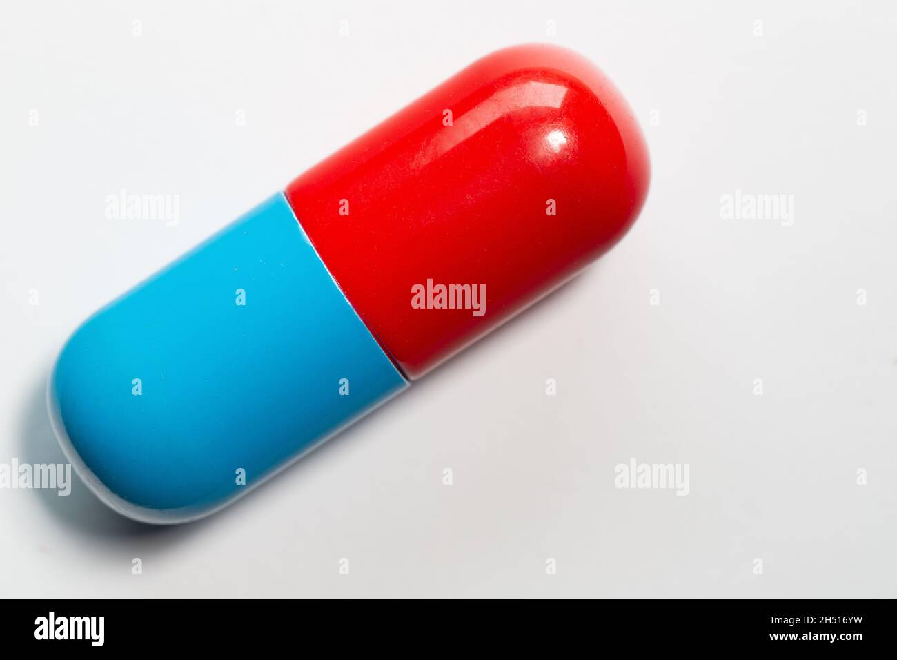 close up of a blue and red pill isolated against a white background and ...