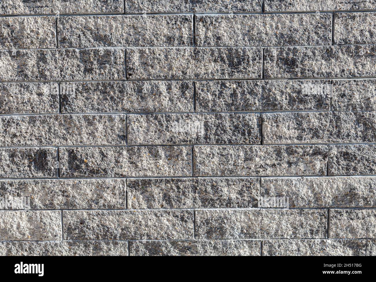 Solid stone wall as creative background texture Stock Photo - Alamy