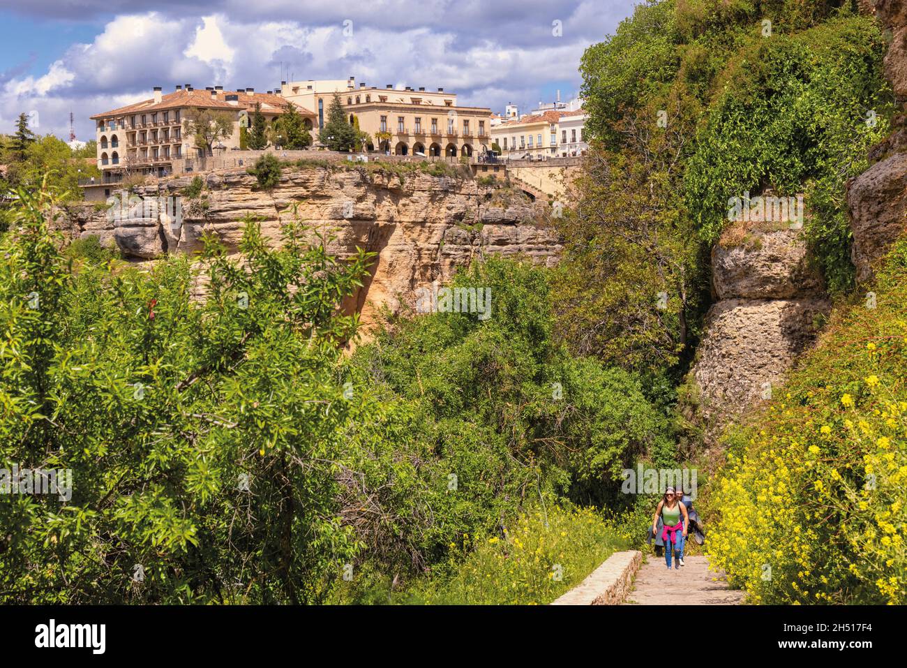 Ronda seen from the Tajo gorge. The hikers are ascending from the path ...