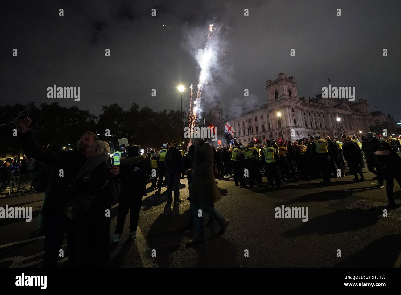 A protestor lets off fireworks whilst taking part in the Million Mask ...