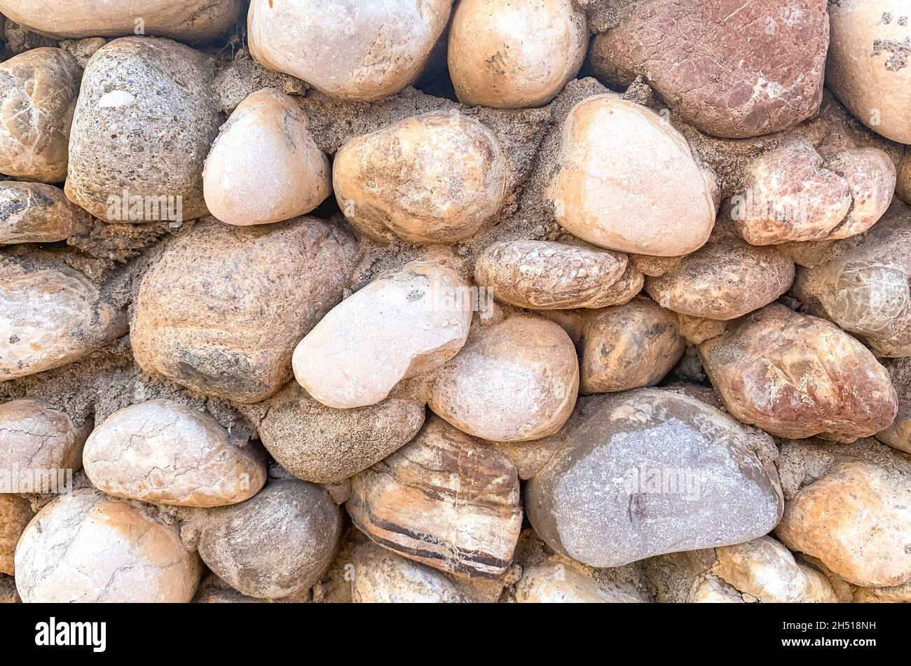 Background, texture, wall of round natural stone Stock Photo - Alamy