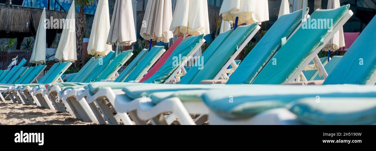 Empty blue sunbeds on a modern beach Stock Photo - Alamy