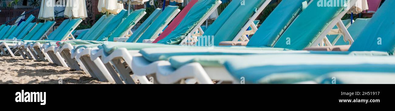 Empty blue sunbeds on a modern beach Stock Photo - Alamy