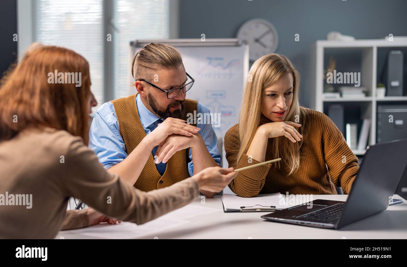 Business partners using laptop hi-res stock photography and images - Alamy