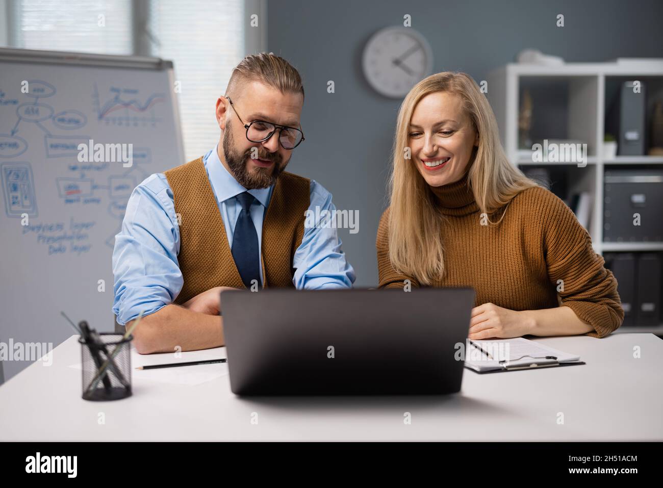 Office workers using laptop Stock Photo - Alamy
