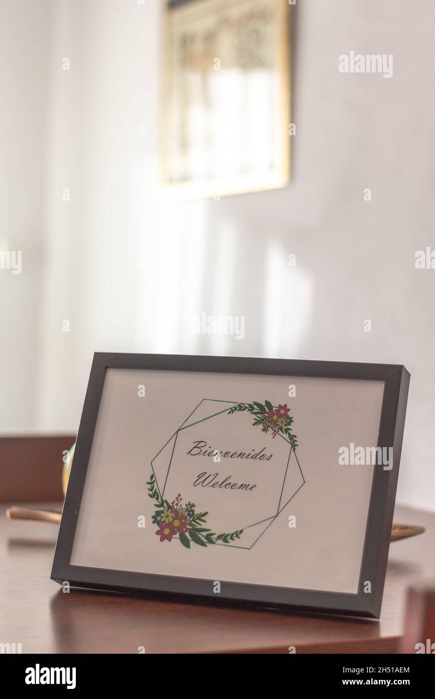 Vertical shot of a welcome card in a frame on a table Stock Photo - Alamy