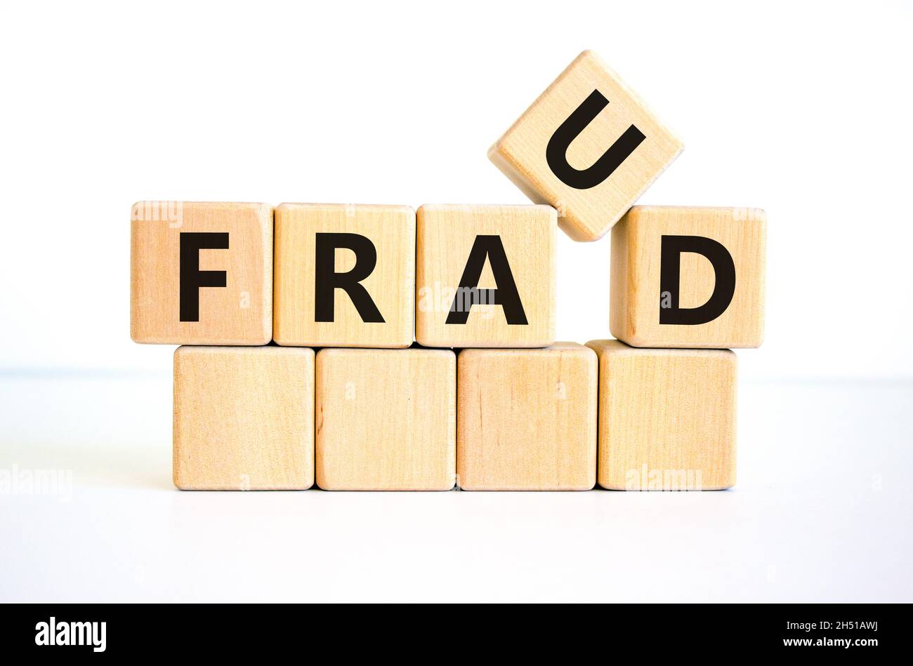 Fraud symbol. The concept word 'fraud' on wooden cubes on a beautiful ...
