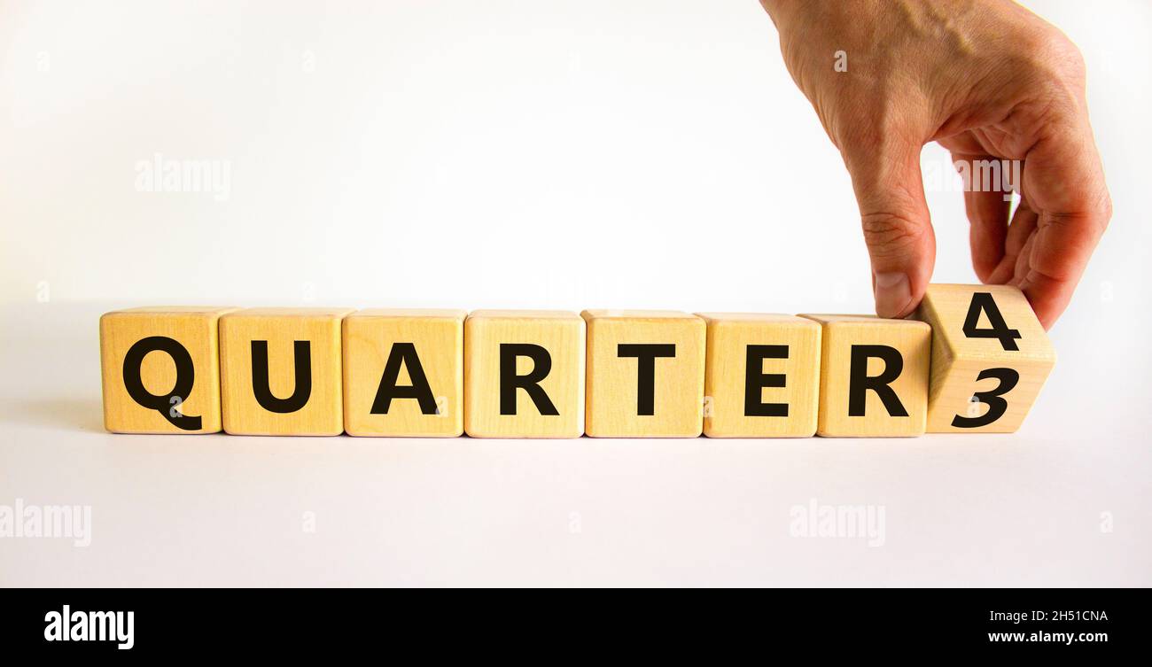 From 3rd to 4th quarter symbol. Businessman turns a cube and changes ...