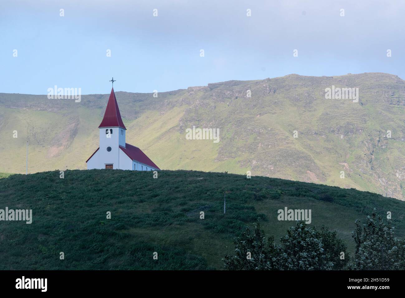 Landscape of Vik i Myrdal Church on a hill on summer day in Vik Stock ...