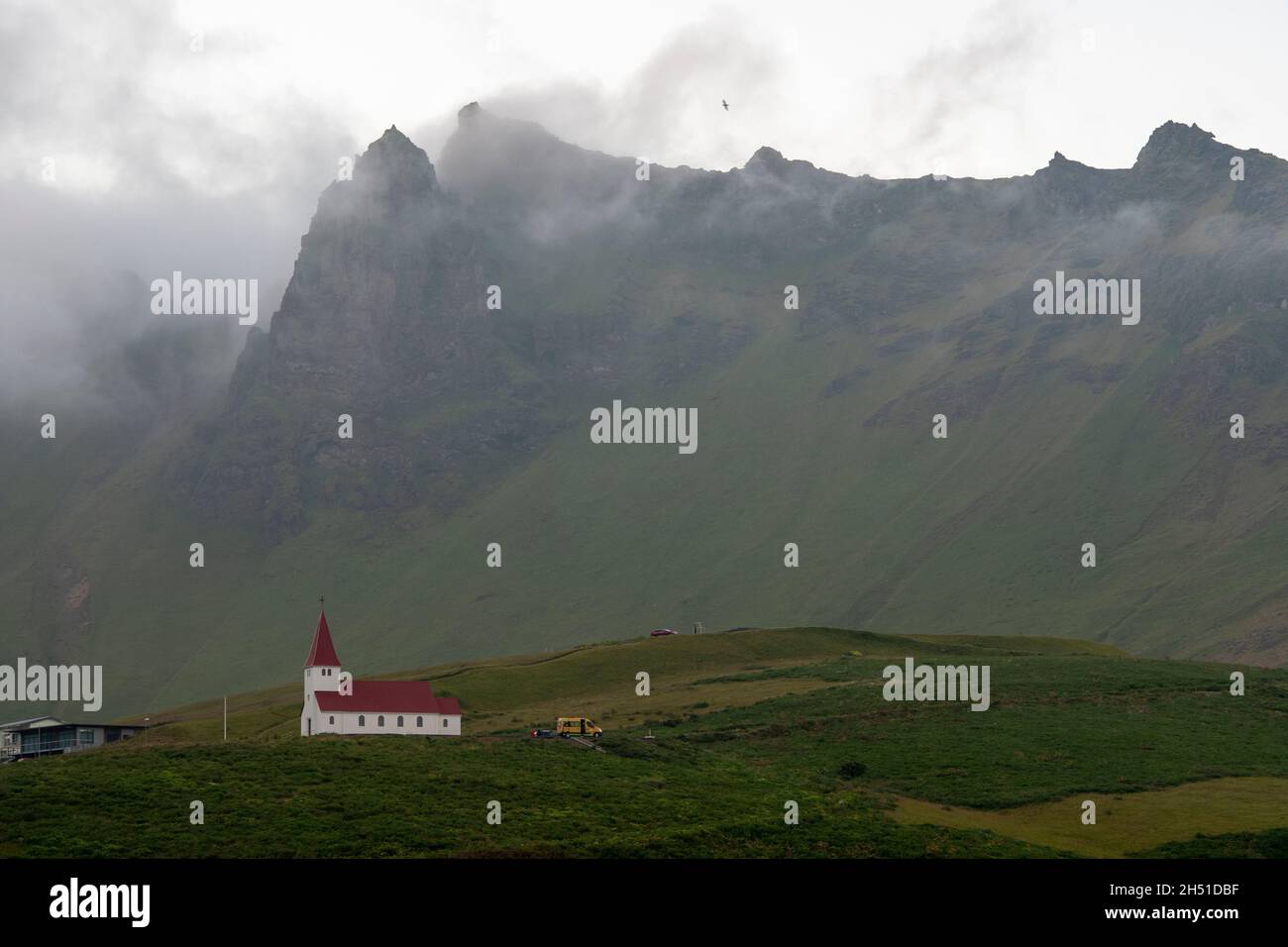 Landscape of Vik i Myrdal Church on a hill on summer day in Vik Stock ...