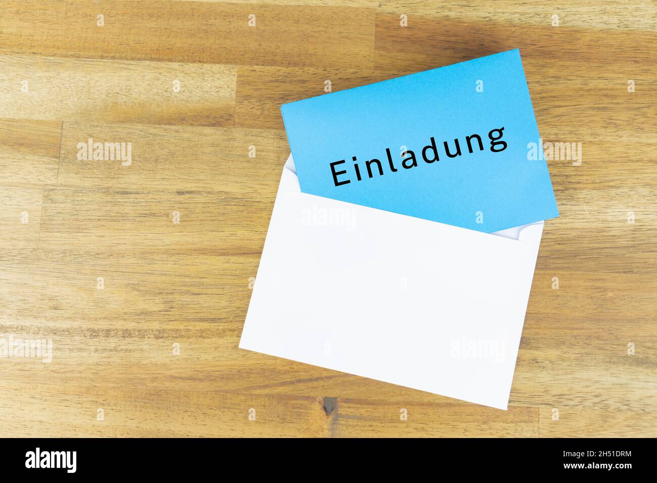 Envelope with a blue note with the german words for invitation Stock ...