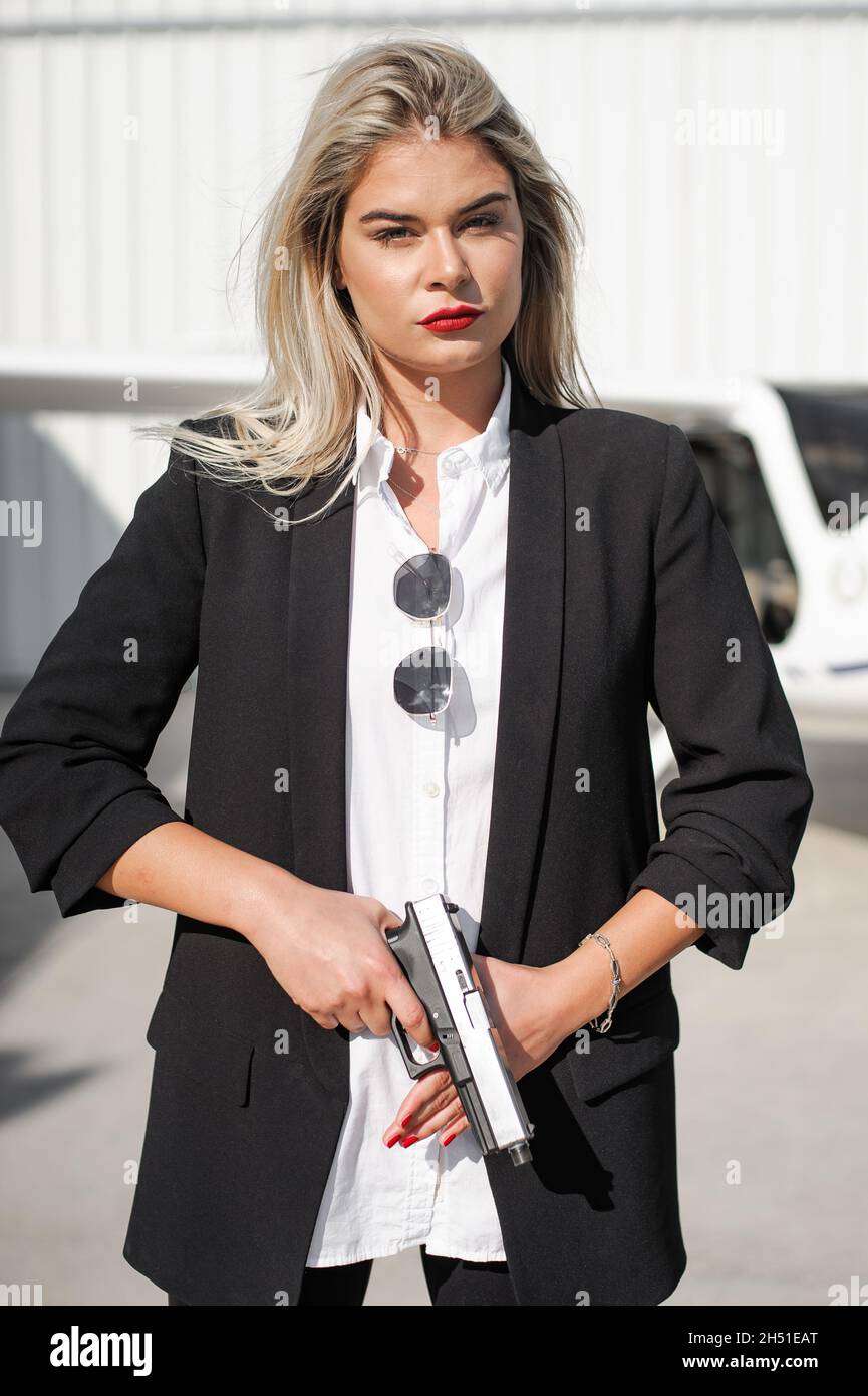 Beautiful professional female spy agent bodyguard posing with gun ...