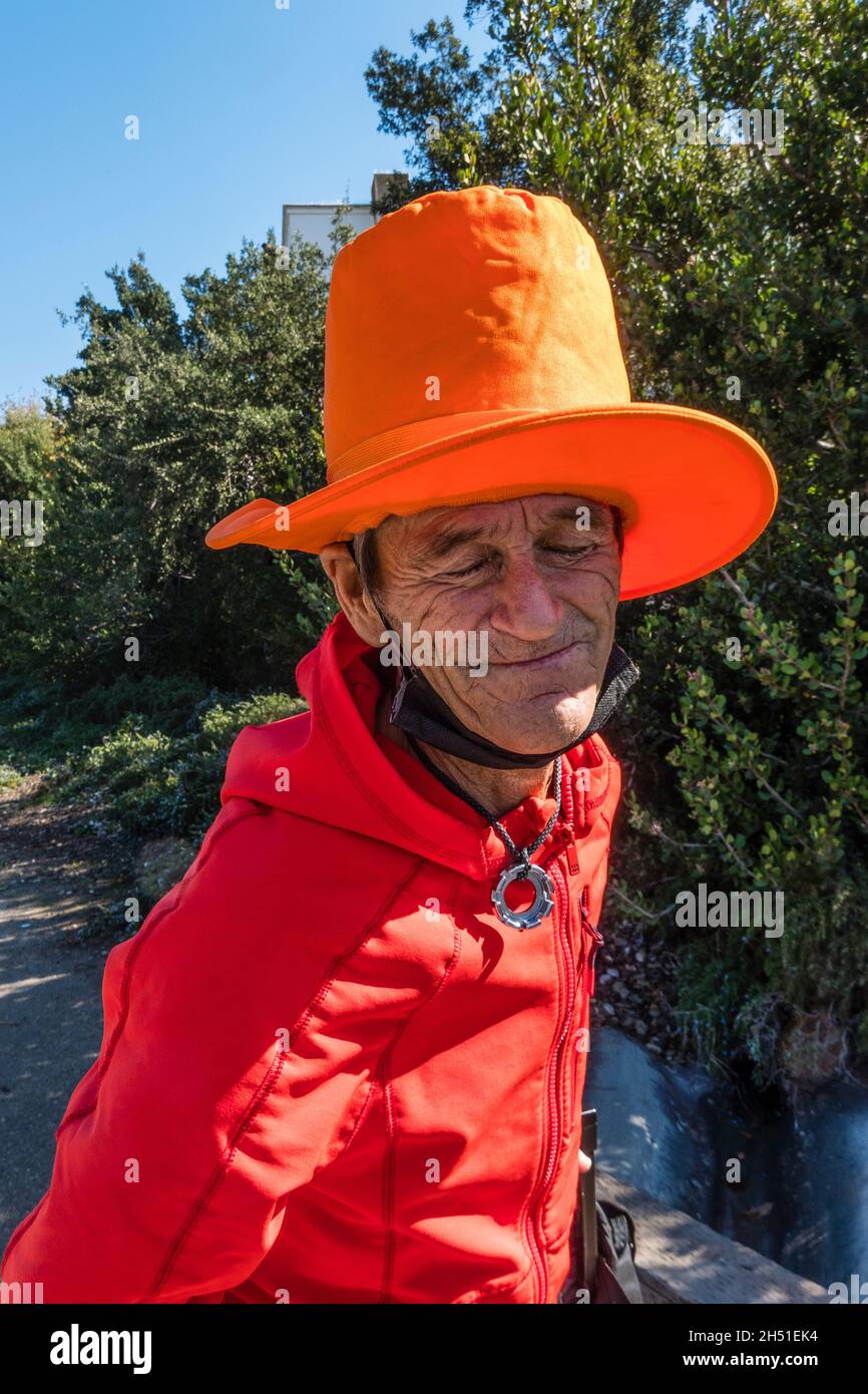 Rand, the street person, dressed in bright colors of red and orange ...