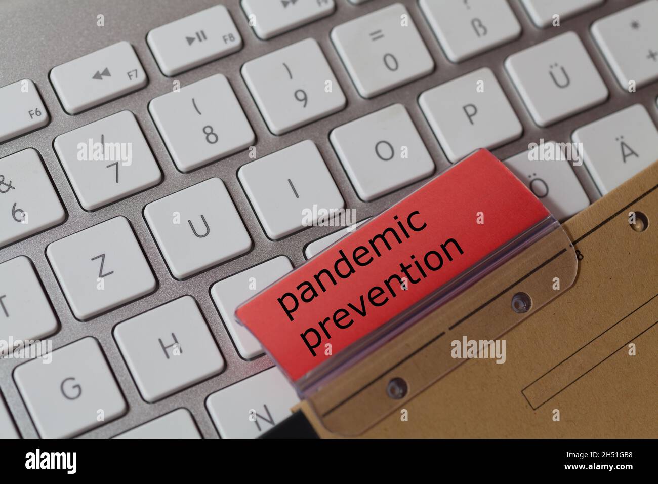 Hanging folder with red tab on which pandemic prevention is noted. The ...