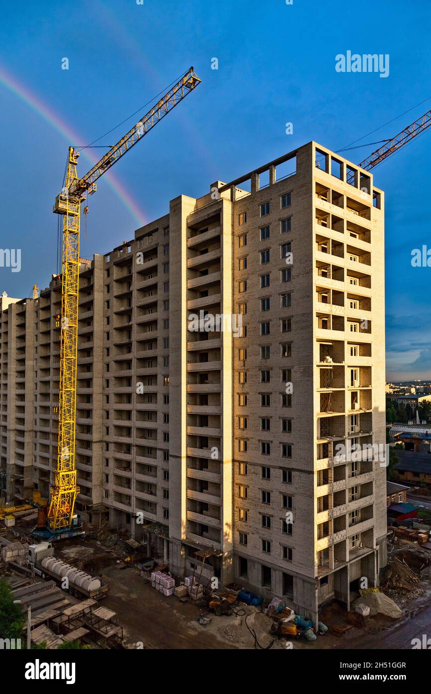 Yellow construction building cranes on the construction site of a large ...