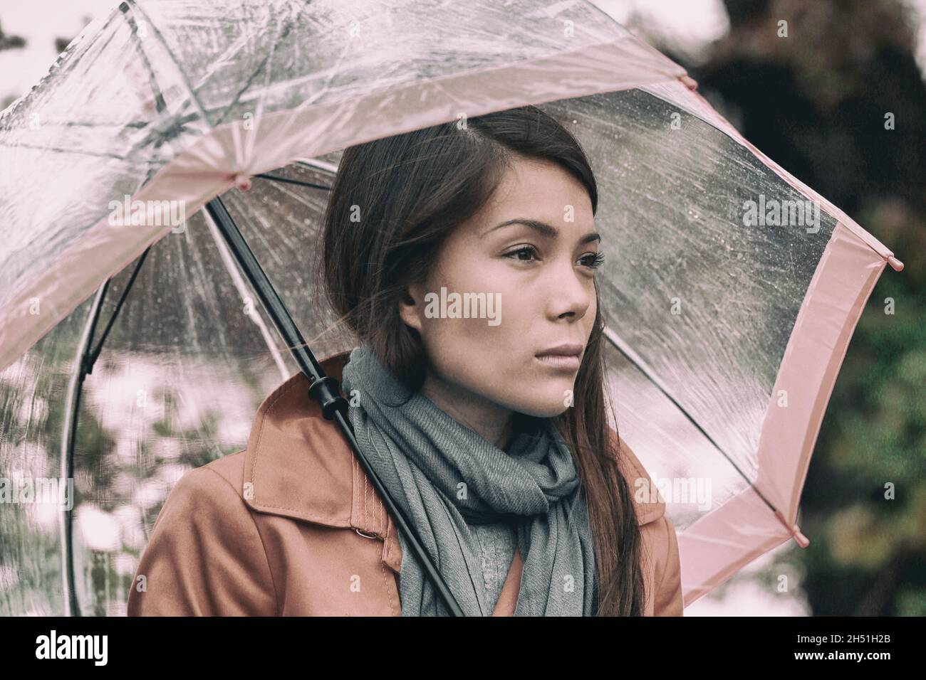 Autumn rainy grey day sad girl pensive. Asian woman in depression ...