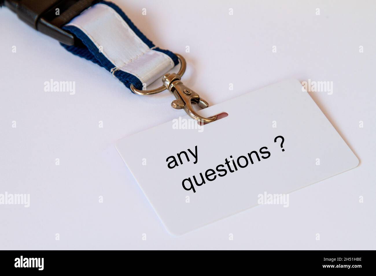 The words any question on a white name tag on a tape Stock Photo - Alamy