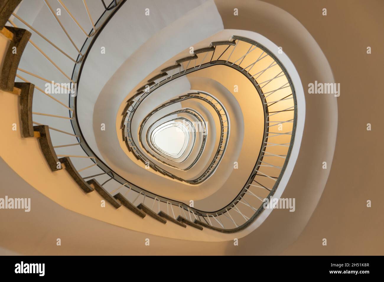stairwell from the 1950s with typical stair railing and yellow warm ...
