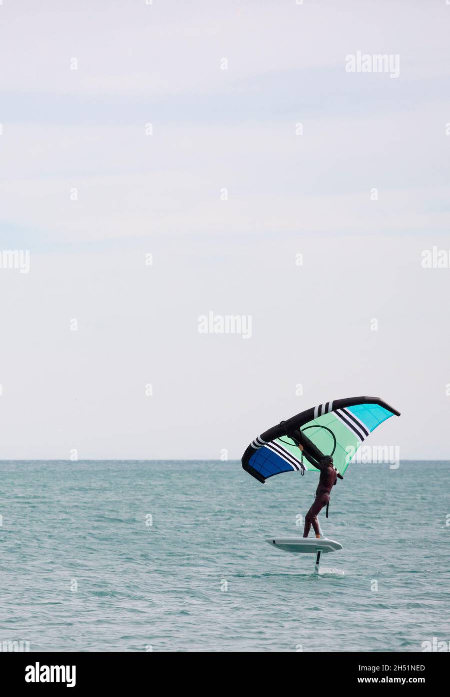 sportsman with wingfoil sailing, in the sea Stock Photo - Alamy