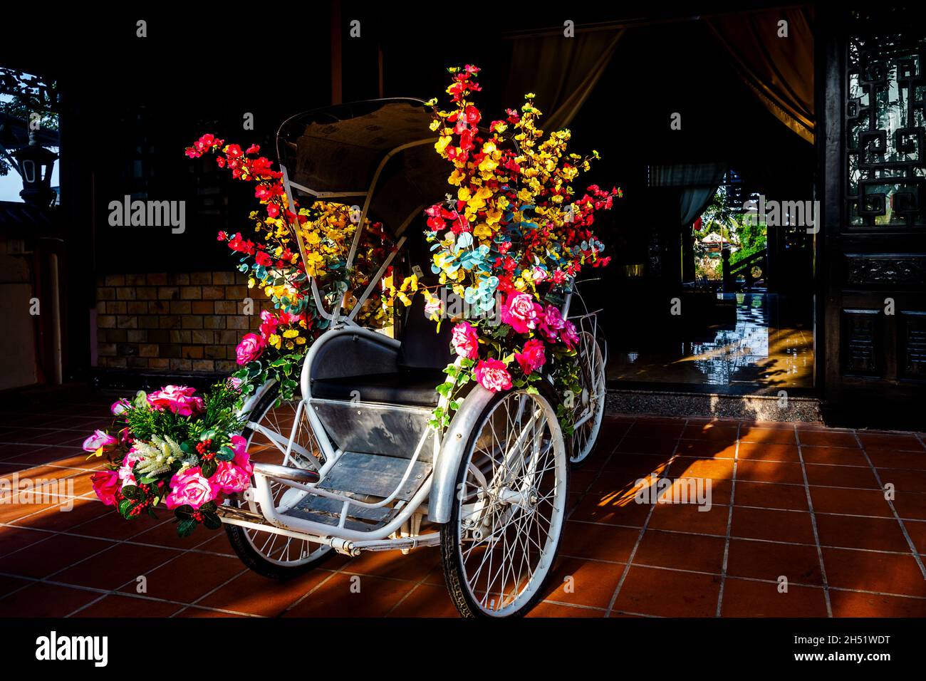 Inside a Cafe with flowers decorating rickshaw in Hue, Vietnam Stock ...