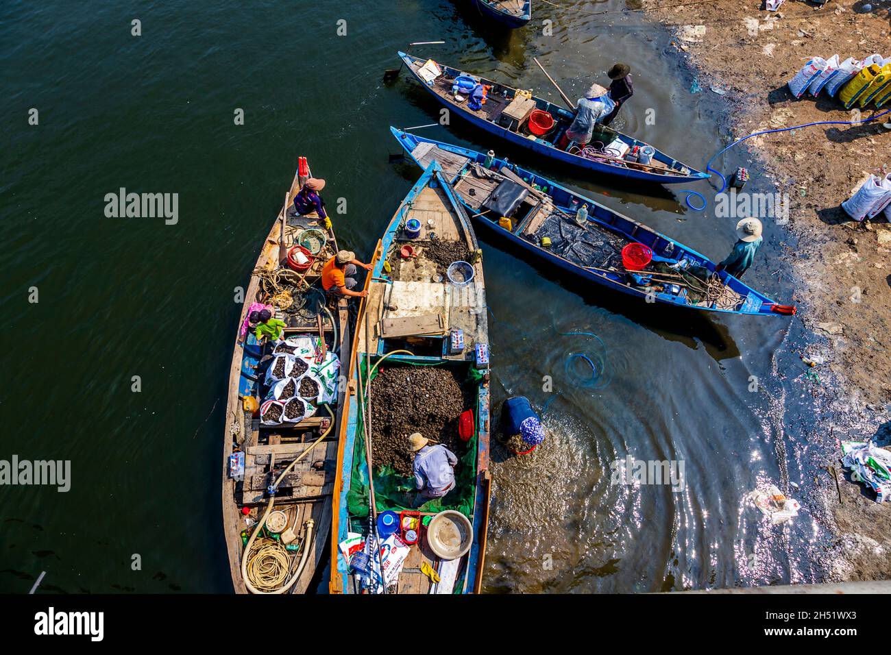 Cargo of rice loaded on the small boats on the Truong Giang river by ...