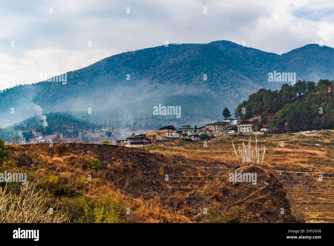 Traditional village and farm fields on the hillside in Bhutan in ...