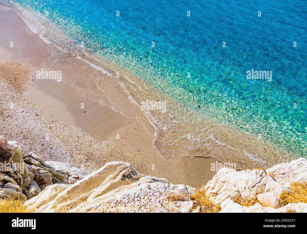 Top view of sandy beach, rocks and turquoise ocean water with small ...