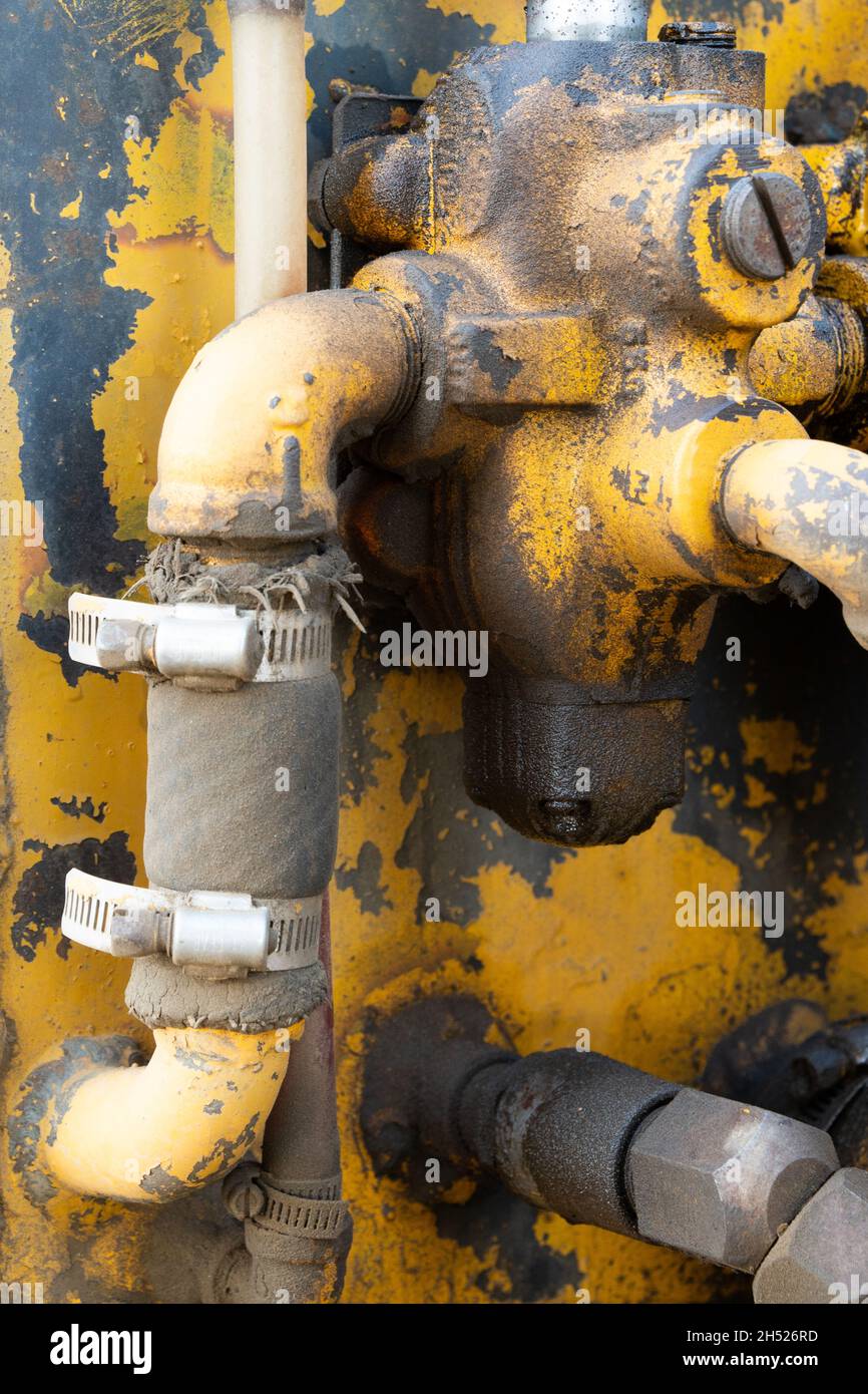 Old rusty yellow tractor hydraulic manifold Stock Photo - Alamy