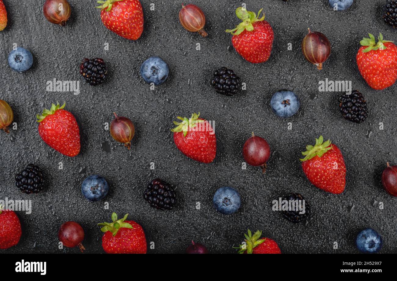Flat lay view at ripe bilberry strawberry raspberry blackberry and ...