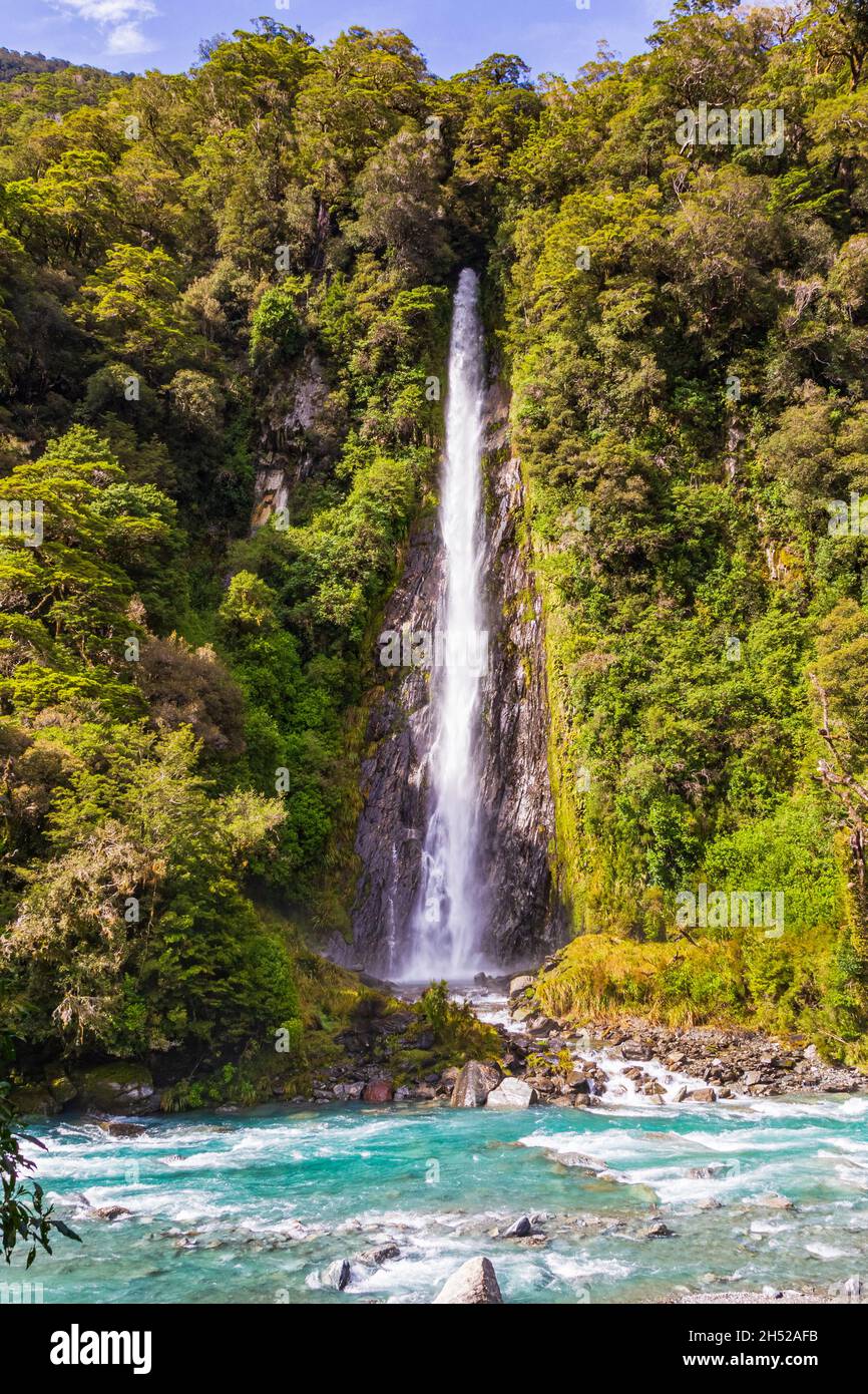 Landscapes of South Island. Small high waterfall among the greenery ...