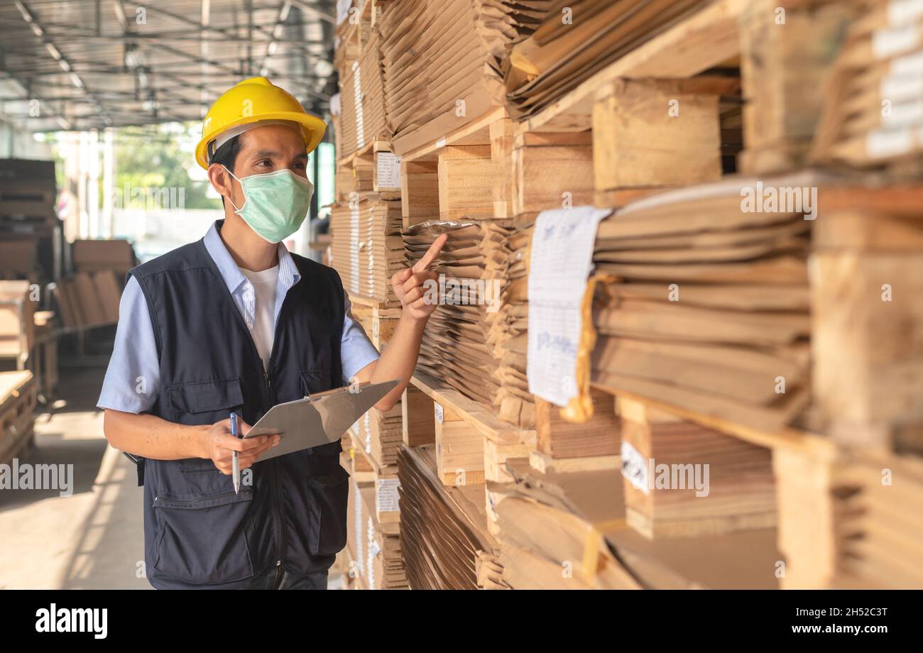 Worker checking raw material inventory in factory Stock Photo - Alamy