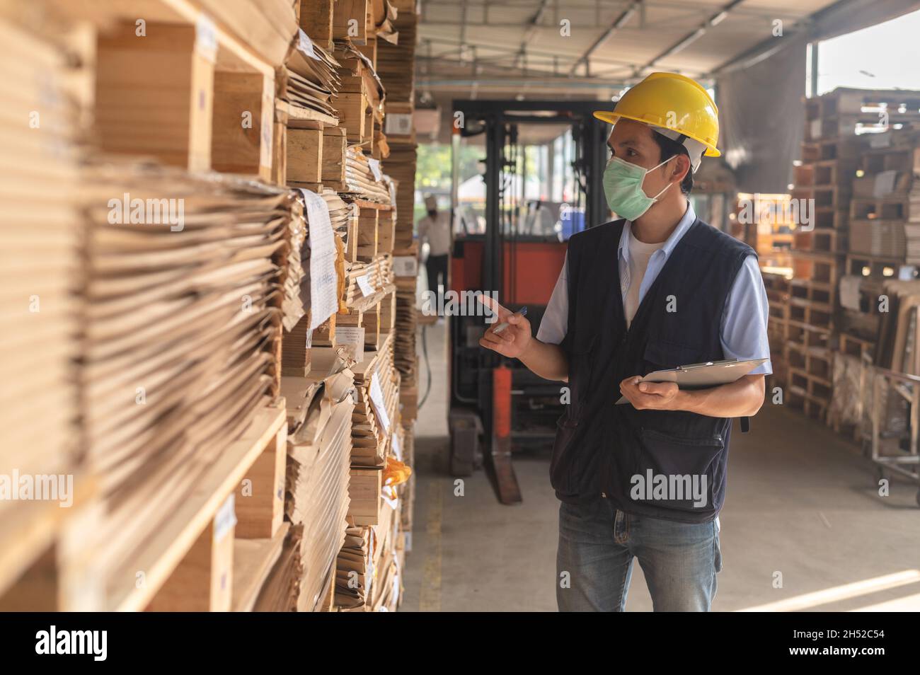 Worker checking raw material inventory in factory Stock Photo - Alamy
