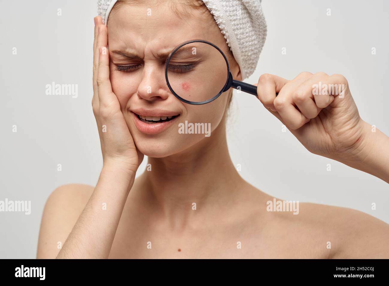 beautiful woman with a magnifying glass in hand skin problems Stock ...