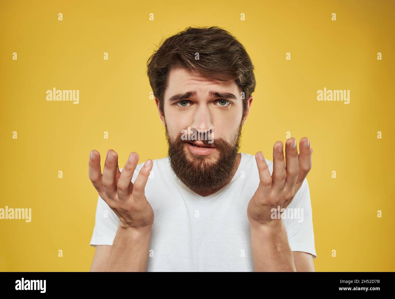 Man in a white t-shirt irritated facial expression close-up Stock Photo ...