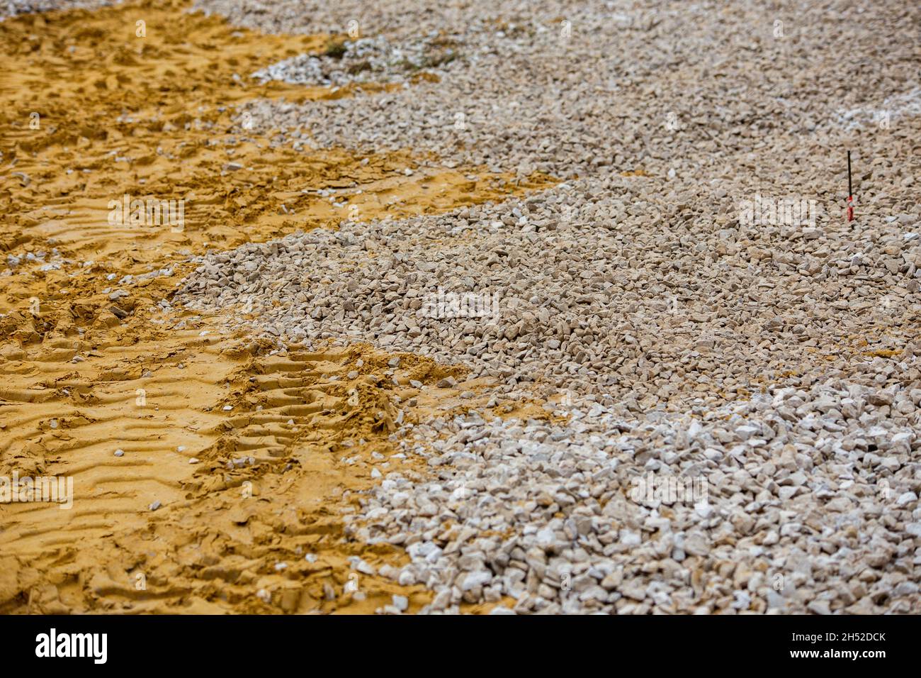 sand and gravel flat area on construction site full frame background ...