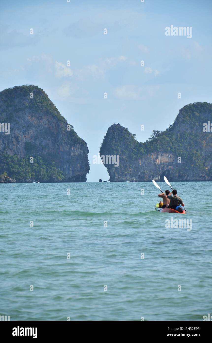 Thai people and foreign travelers rowing canoe kayak in sea for relax ...