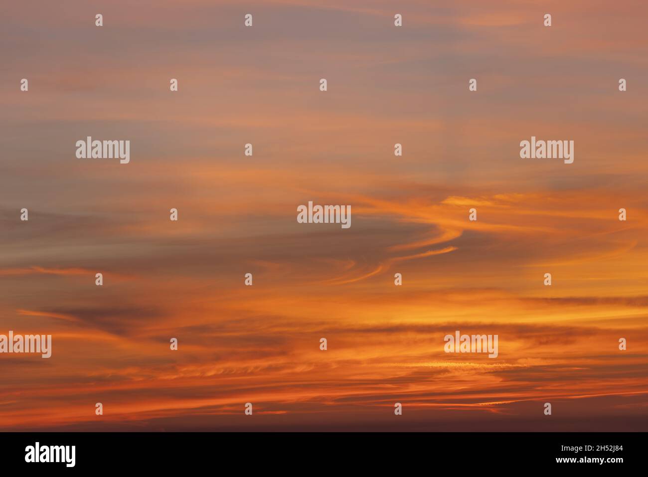 The setting sun lighting up the cloud cover Stock Photo - Alamy