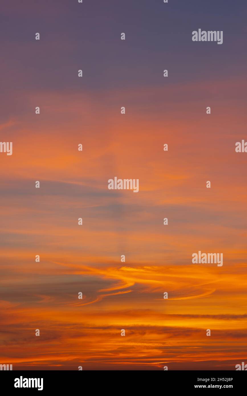 The setting sun lighting up the cloud cover Stock Photo - Alamy
